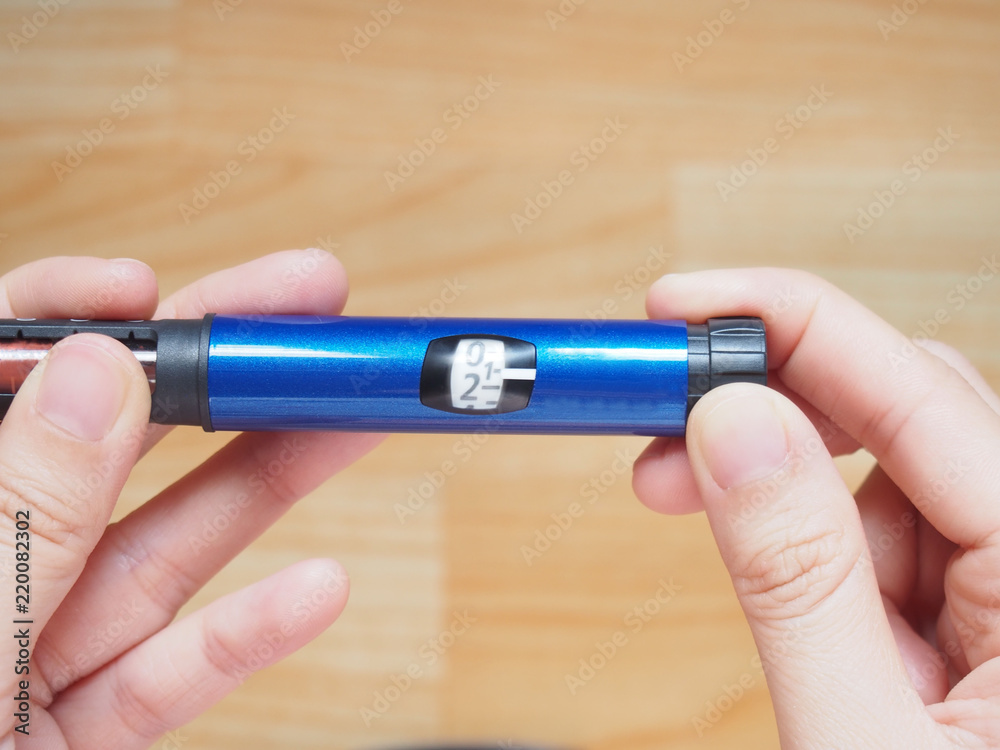 Diabetes patient turn knob on end of insulin pen and dial up correct ...