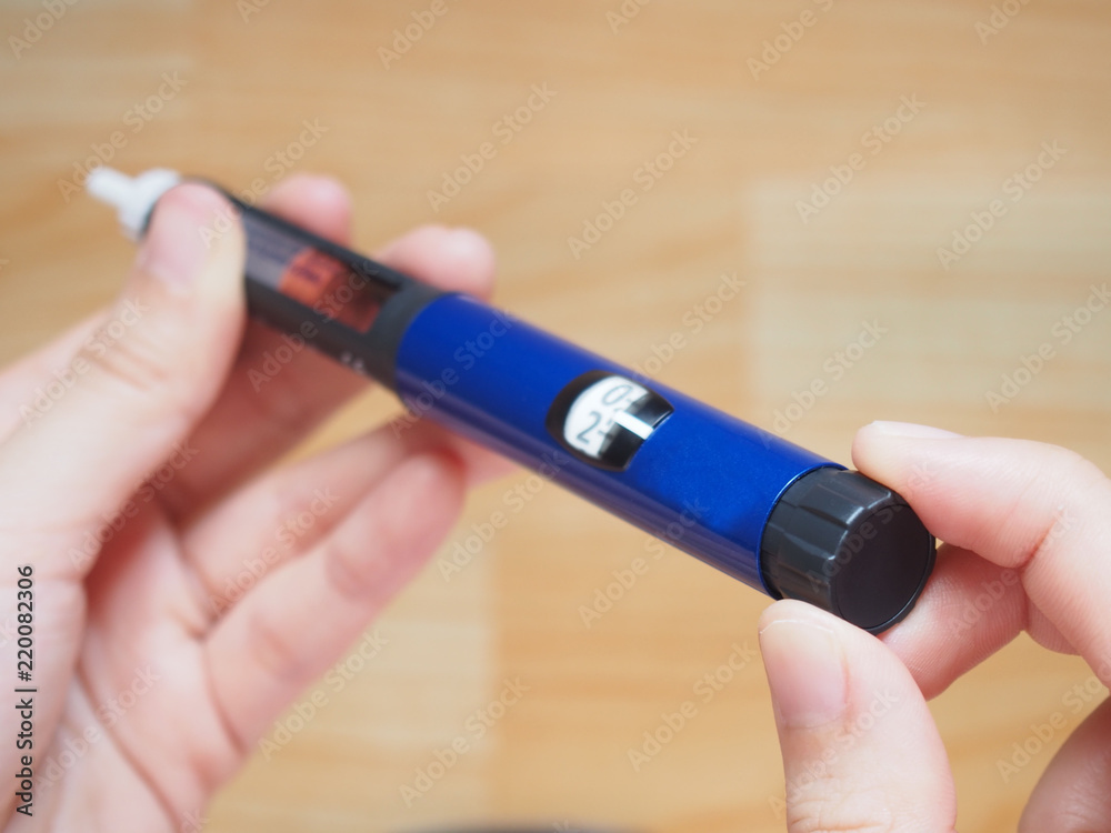 Diabetes patient turn knob on end of insulin pen and dial up correct ...