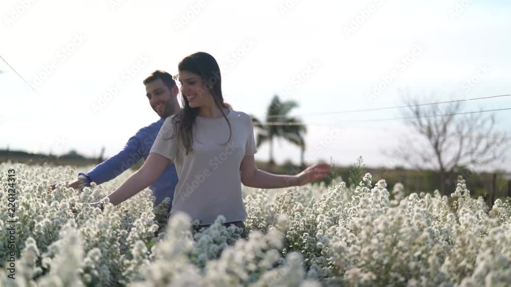 Romantic Couple on a Love Moment in a field of flowers Stock Video ...