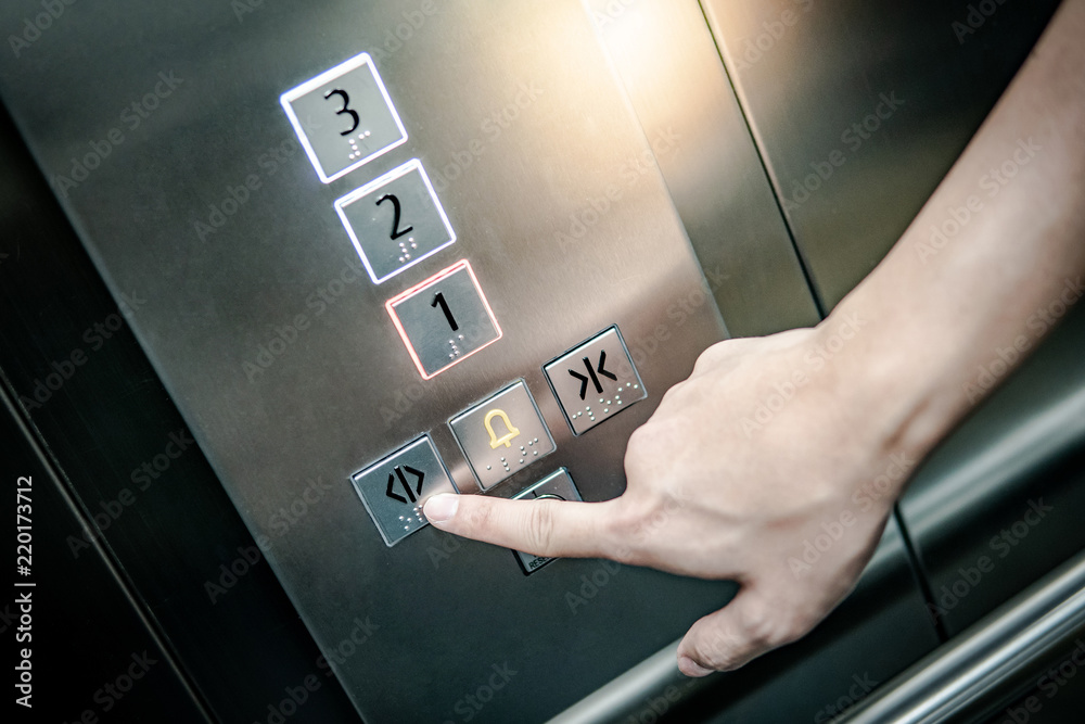 Male forefinger pressing on the open door button in elevator (lift ...