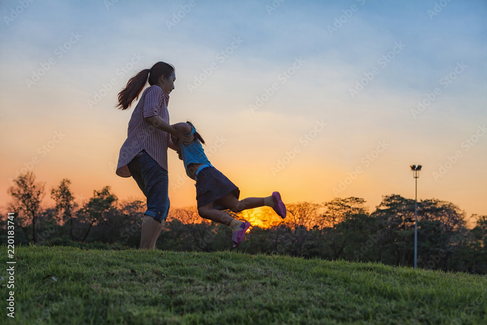 Silhouette of a happy little girl child running into the arms of his ...