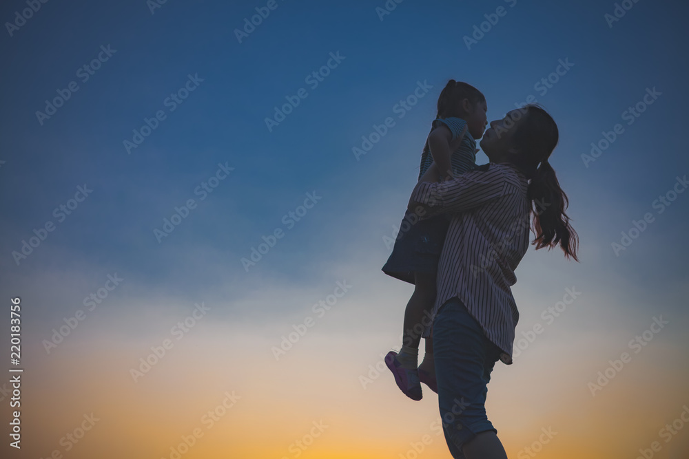 Silhouette of a happy little girl child running into the arms of his ...