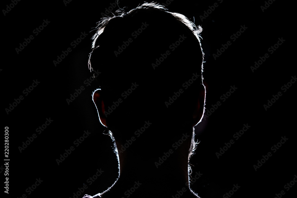 lighten portrait silhouette of a human head in the dark background ...