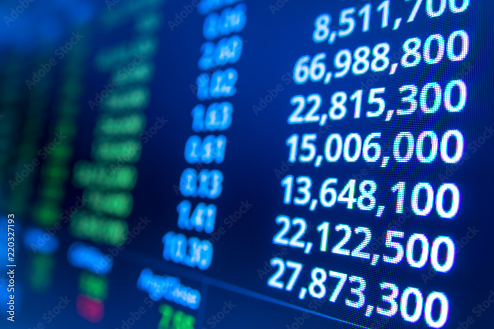 Stock market graph analysis. Stock market data on LED display on laptop ...