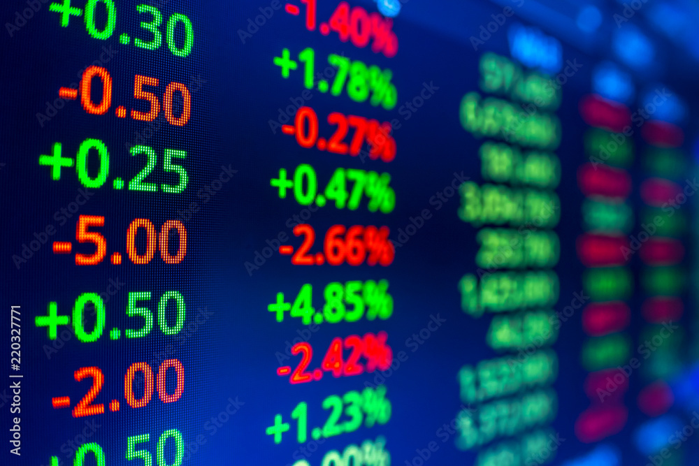 Stock market graph analysis. Stock market data on LED display on laptop ...