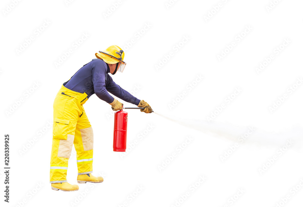 Fireman in yellow fire fighter uniform using fire extinguisher from ...
