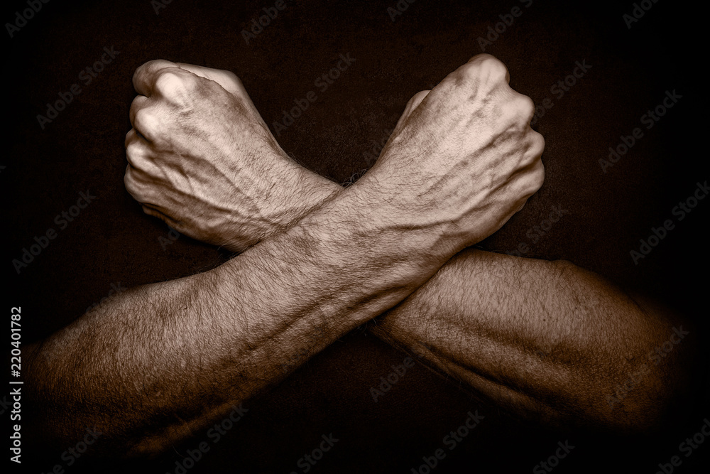 Man's crossed arms as a defense or shield to protect the body. A ...