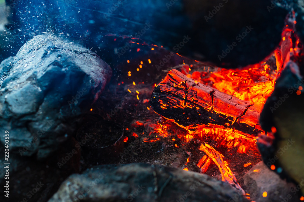 Smoldered logs burned in vivid fire close up. Atmospheric background ...