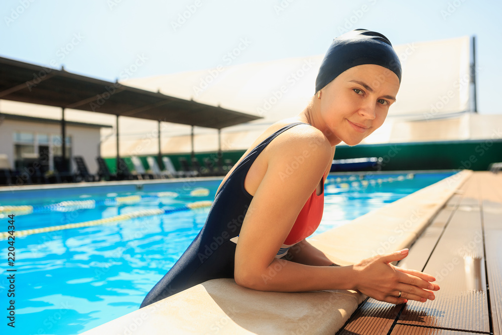 The portrait of happy smiling beautiful woman at the swimming pool ...