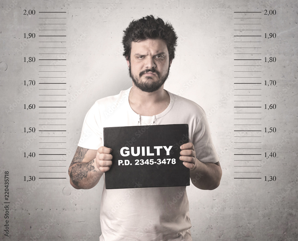 Caught guilty man with ID signs on his hand. Stock Photo | Adobe Stock