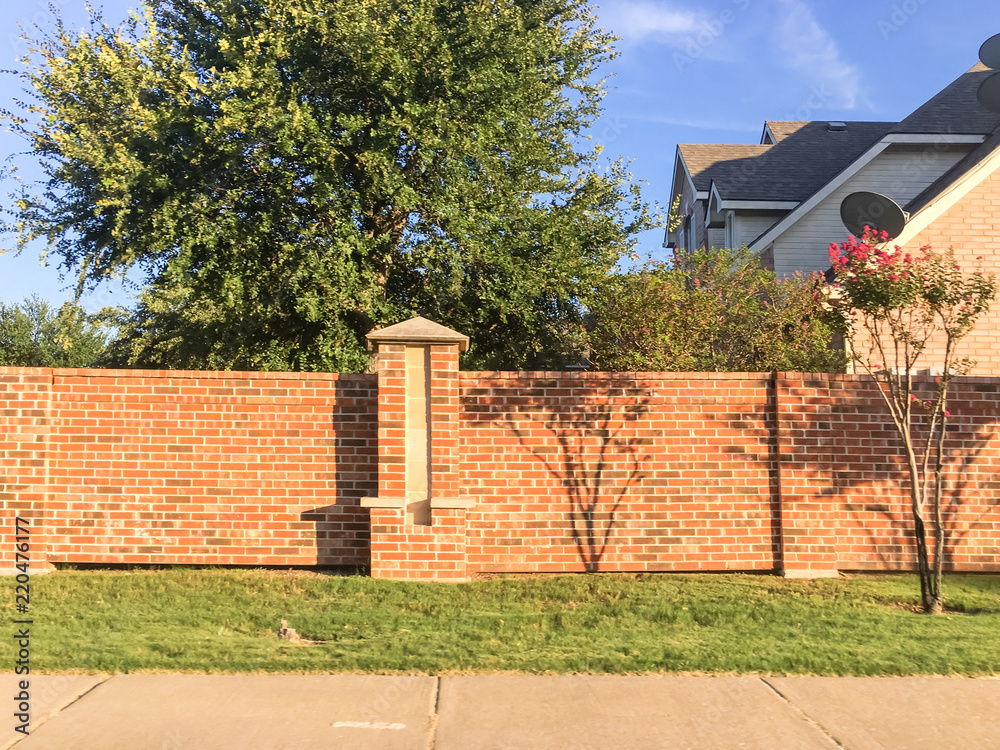 Red brick subdivision walls in Irving, Texas, USA, barrier between ...