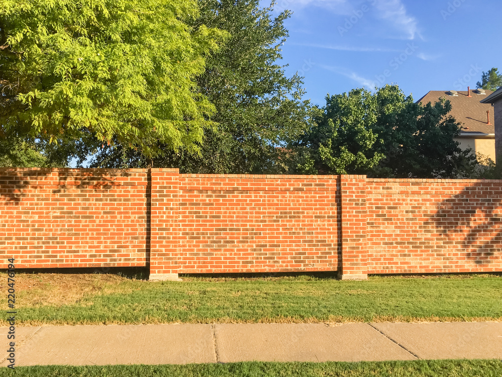 Red brick subdivision walls in Irving, Texas, USA, barrier between ...