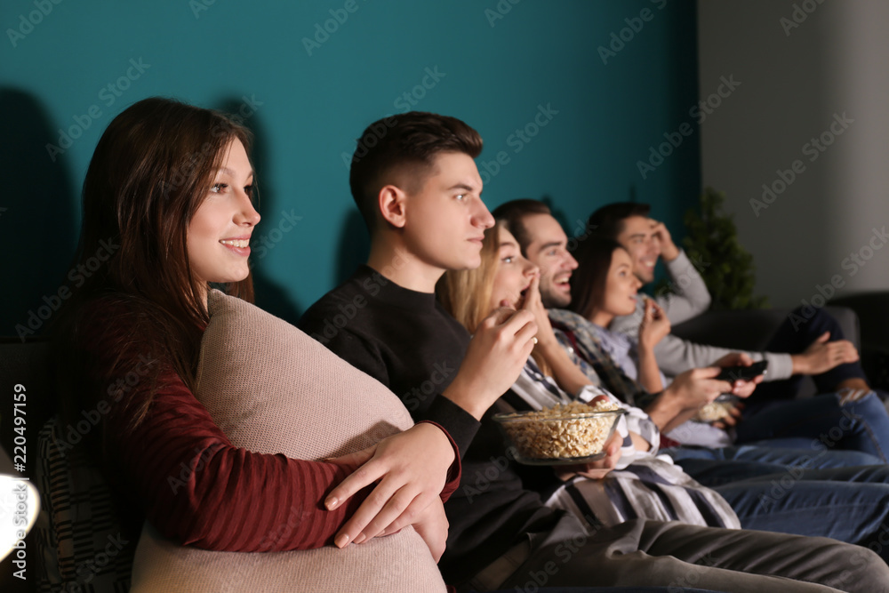 People Watching A Movie At Home
