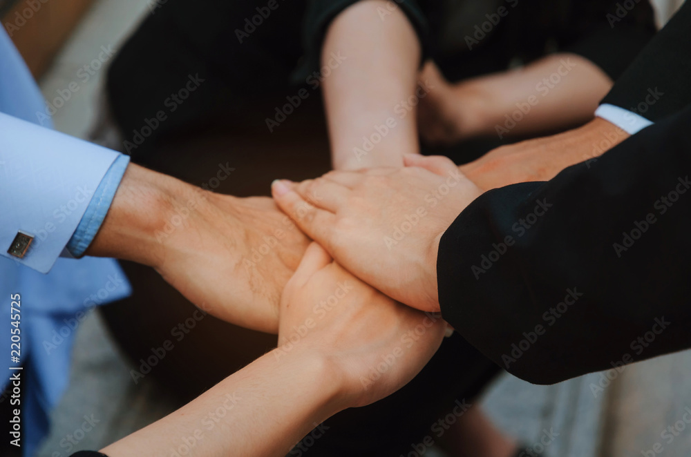 hand of group of business people team joining hands together in the ...