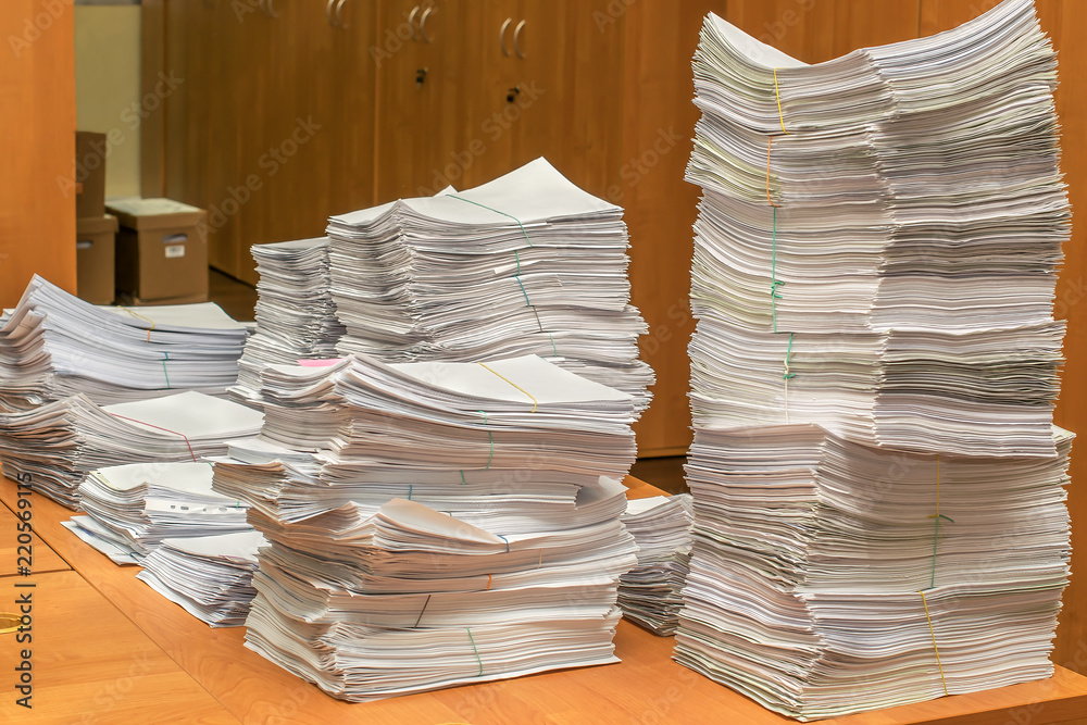 bundles bales of paper documents. stacks packs pile on the desk in the ...