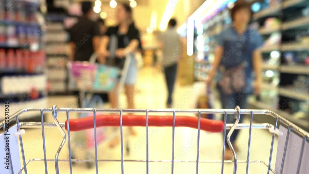 Shopping cart moving through supermarket aisles, trolley in a ...