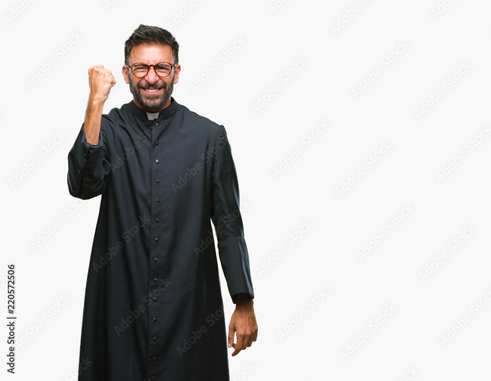 Adult hispanic catholic priest man over isolated background angry and ...