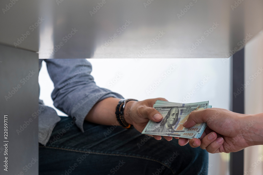 Hands passing money under table corruption bribery, businessman sealing ...