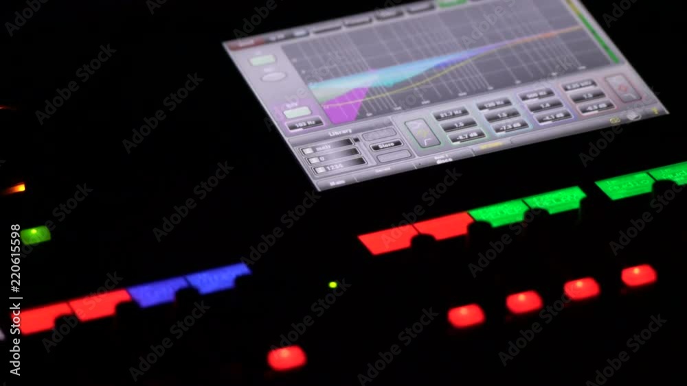 Tracking shot of digital sound mixer with monitor in the dark concert ...
