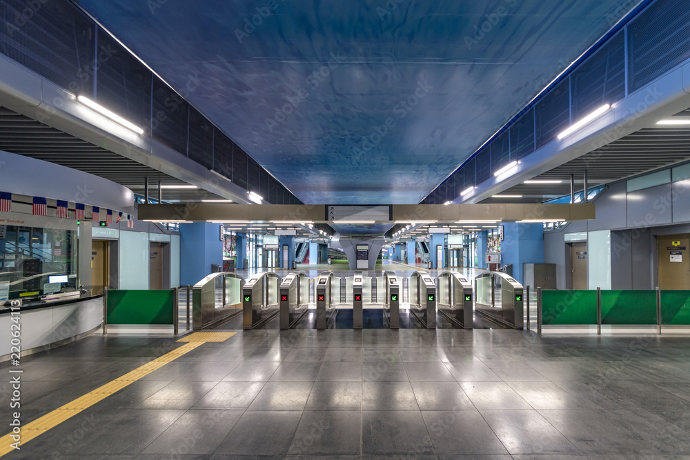 Clean and neat train station with its toll gate reflecting on the ...