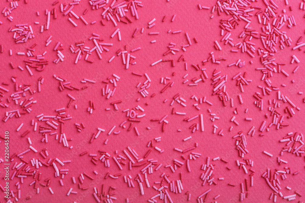 Colorful sprinkles over pink background Stock Photo | Adobe Stock