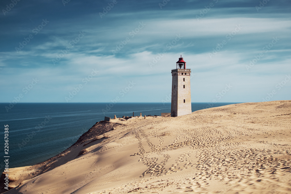 Bright beach sand dunes with the famous danish landmark lighthouse with ...