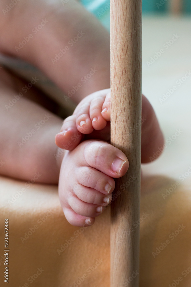 Little feet and cute toes of the baby in the baby crib, Baby's feet ...