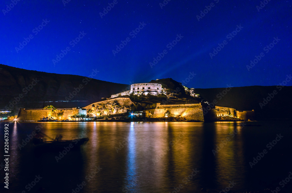 Amazing view of the island of Spinalonga illuminated at night.The ...