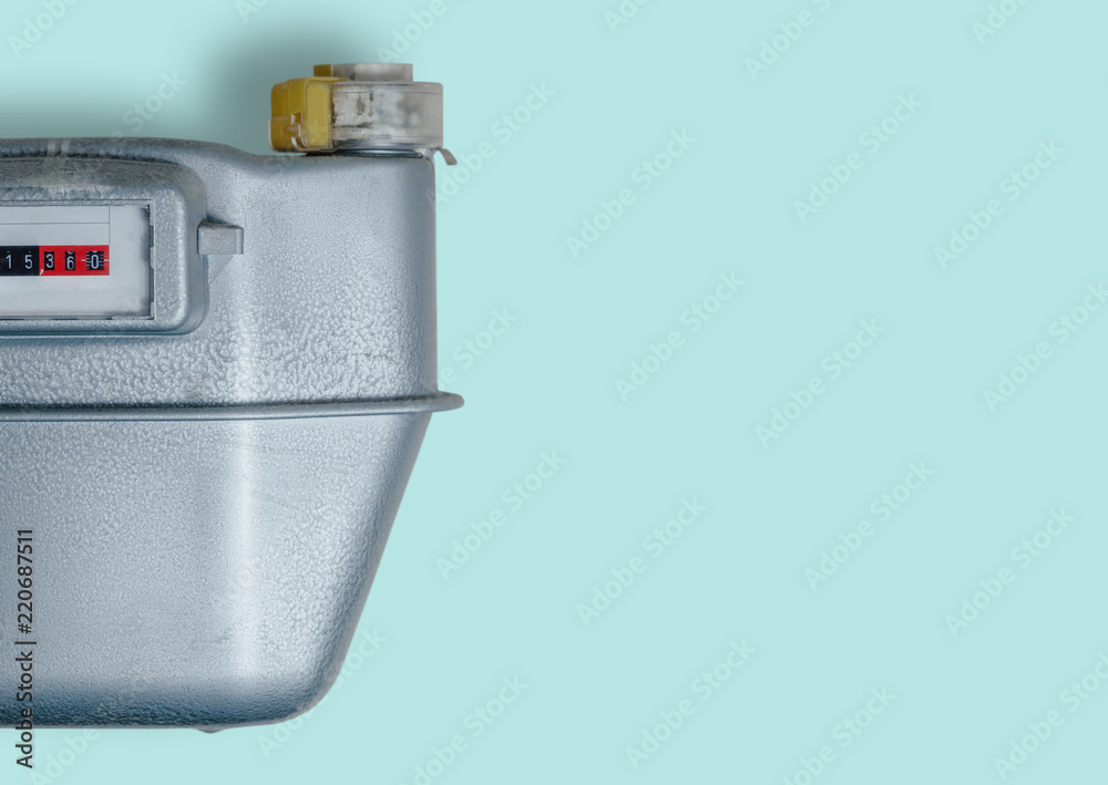 Close-up of a half of a gas meter isolated on a green, blue pastel ...