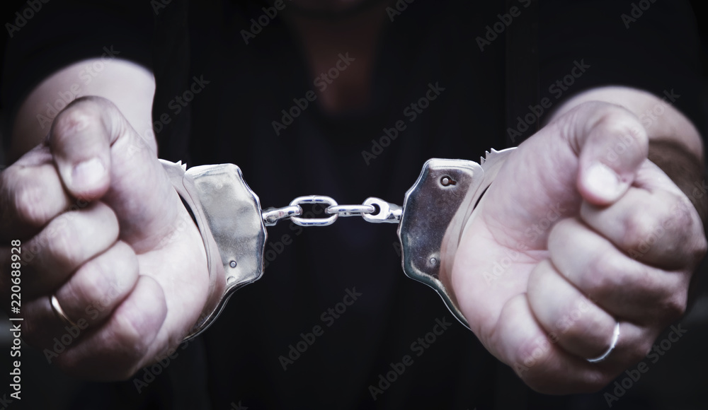 Portrait of handcuffed criminal man imprisoned. Arrest, gangster, pain ...