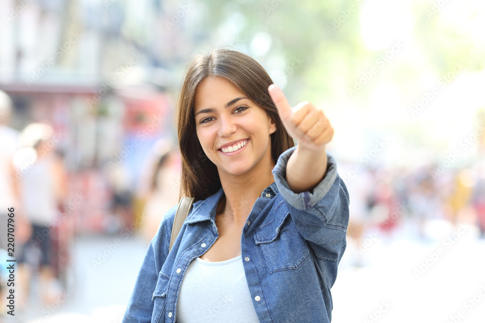 Happy girl posing with thumb up in the street Stock Photo | Adobe Stock