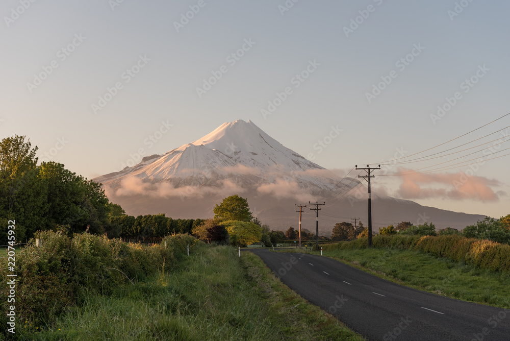 Snow covered Mount Taranaki, or Egmont, an active volcano, viewed at ...