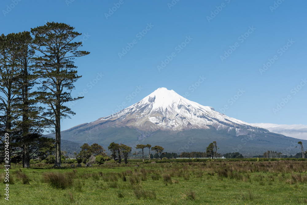 Snow covered Mount Taranaki, or Egmont, an active volcano, viewed ...