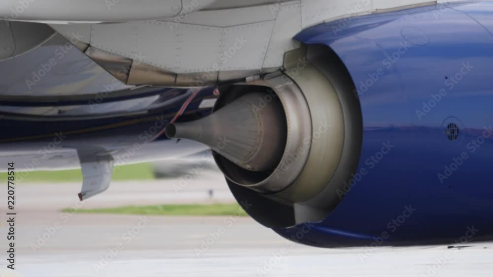 Back part of jet airliner engine. Aircraft moves on taxiway at airport ...
