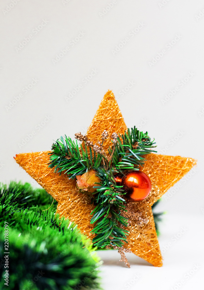 Christmas toy in the shape of an orange star with a ball and a spruce ...