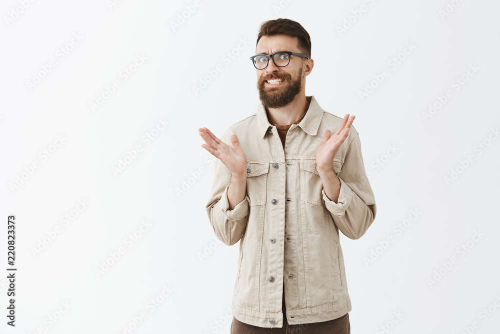 Indoor shot of unsure intense male office worker explaining tough ...