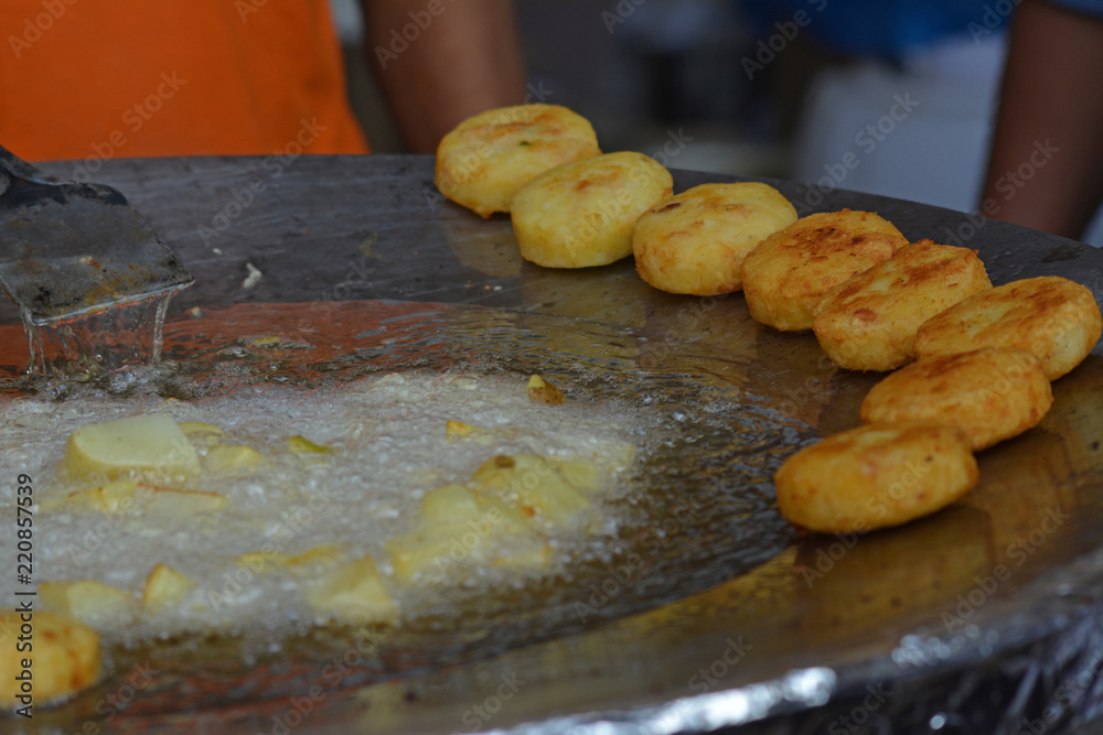 Aloo Tikki (Indian Potato Wedges) an Indian Delicacy getting oil fried ...