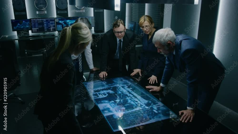 Team of Government Intelligence / FBI Agents Standing Around Digital ...