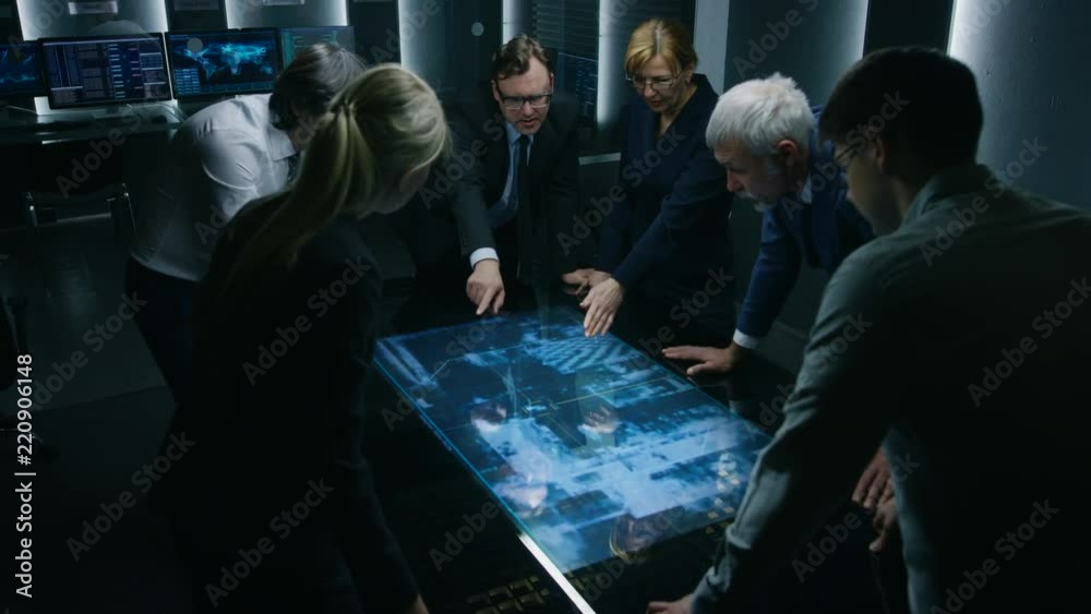 Team of Government Intelligence / FBI Agents Standing Around Digital ...