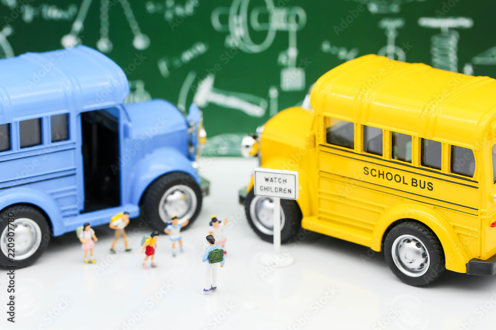 Miniature people : A group of young children getting on the schoolbus ...