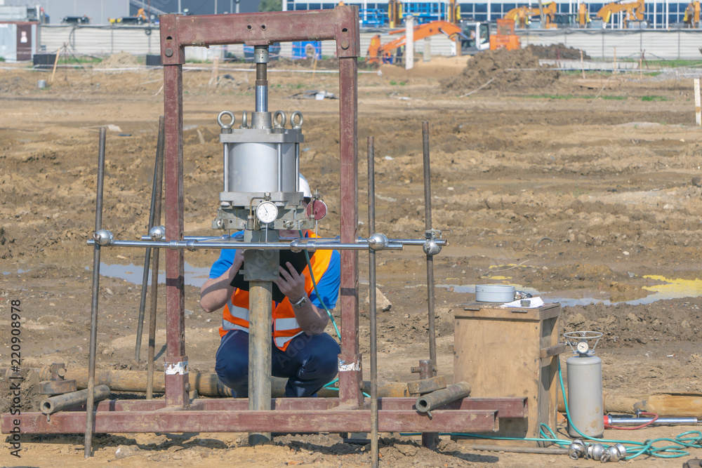 Worker conducts environmental testing of soil at the construction site ...