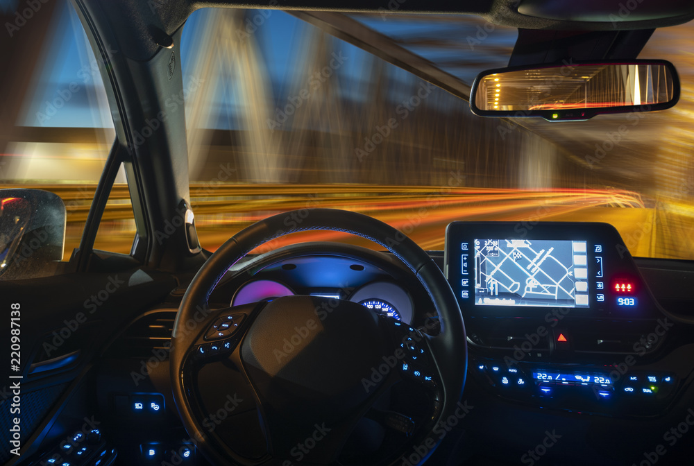 concept of the cockpit of an autonomous car driving at night ...