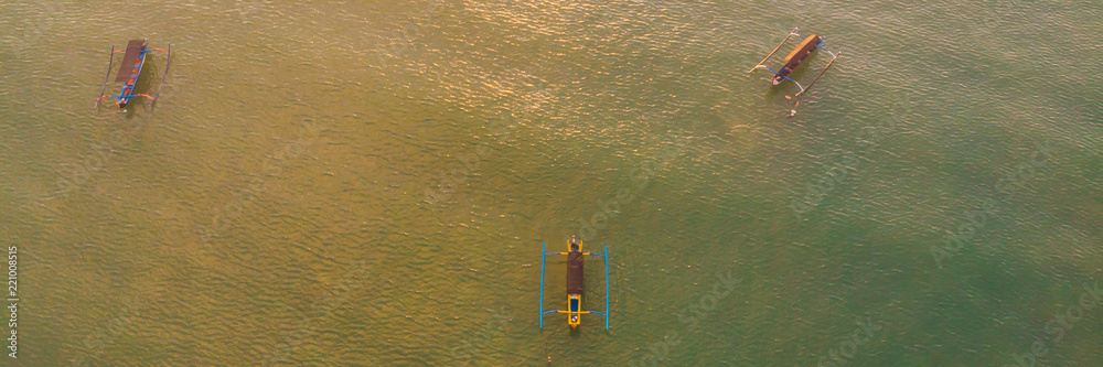 Traditional Balinese boat Jukung at Jimbaran beach at sunset in Bali ...