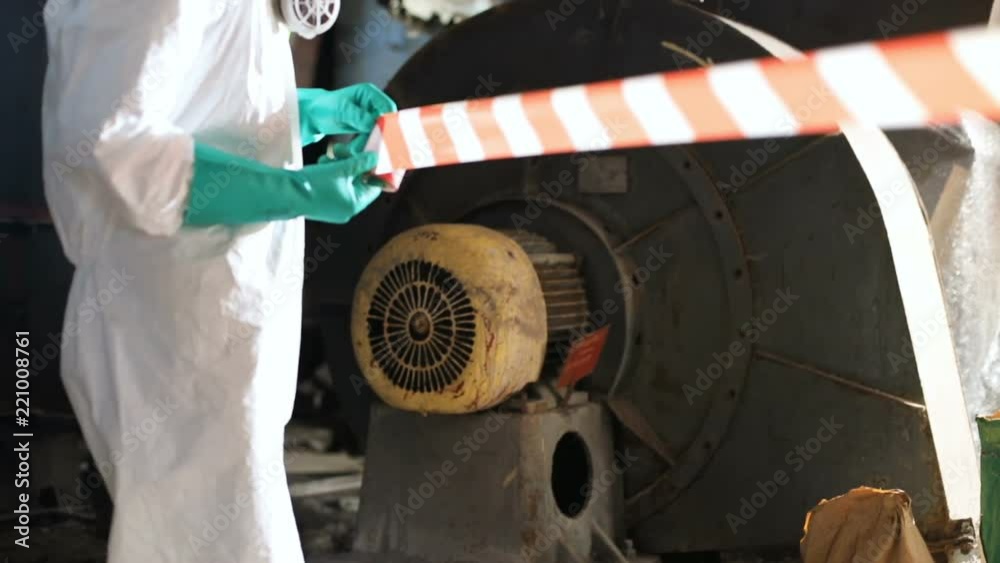 Tall Caucasian man wearing white hazmat suit and green rubber gloves ...