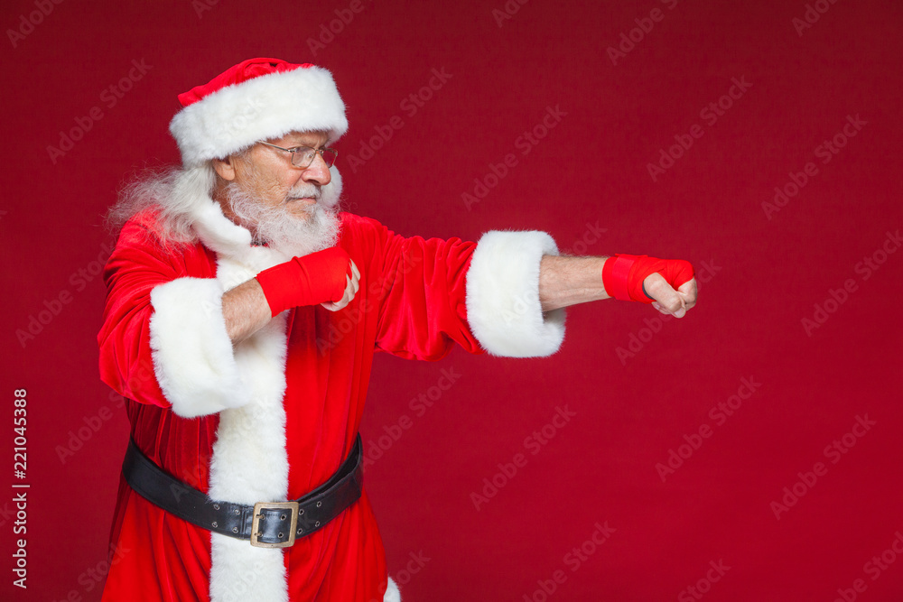 Christmas. Santa Claus with red bandages wound on his hands for boxing ...