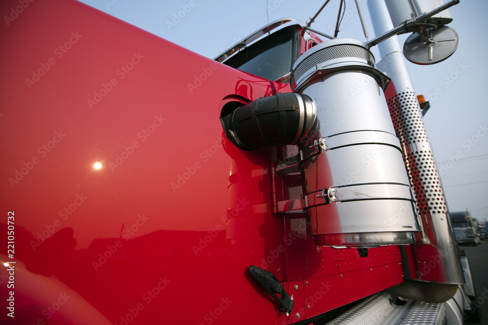 Part of red big rig semi truck tractor cab with chrome accessoriae ...