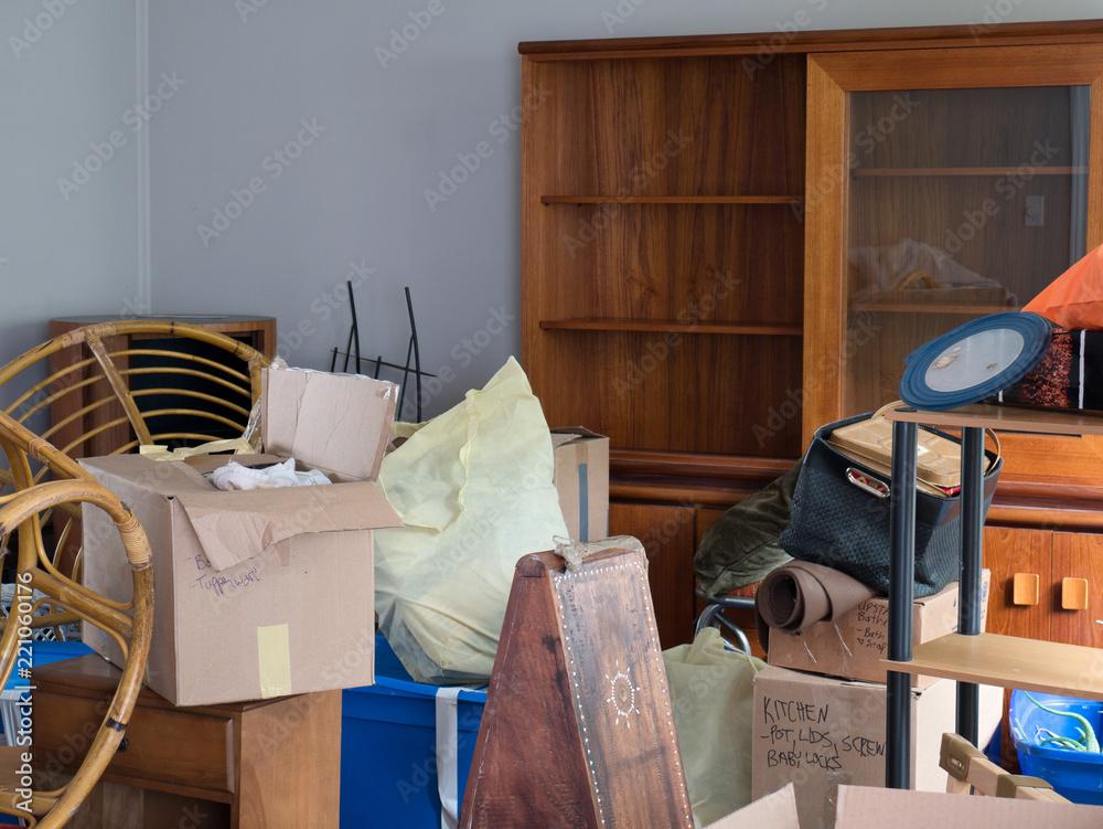 Moving day, lots stuff packed in boxes, bins and bags and furniture ...