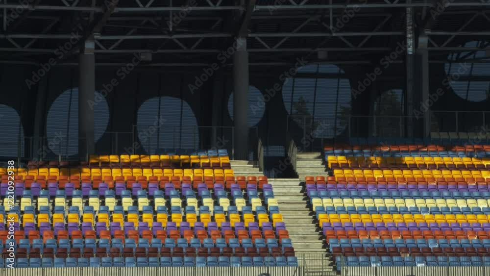 Football stadium with empty tribunes. Empty different colors seats in ...