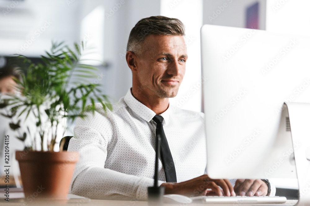 Image of handsome businessman 30s wearing white shirt and tie sitting ...