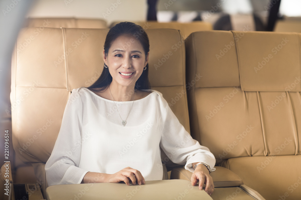 Elegant mature woman travelling by airplane Stock Photo | Adobe Stock